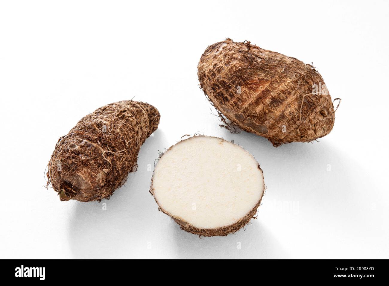 raw whole and cut taro or eddo tuber root Stock Photo - Alamy