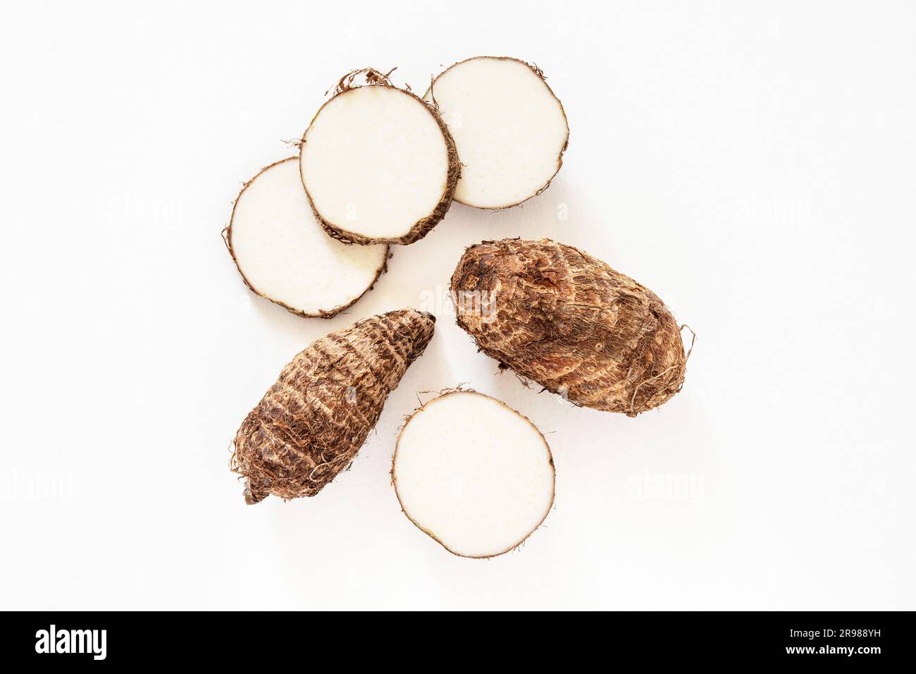 raw whole and cut taro or eddo tuber root Stock Photo - Alamy