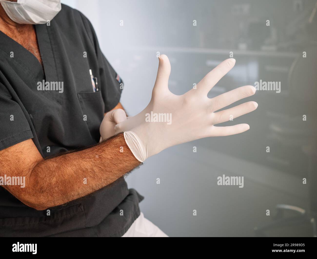 Doctor puts on latex gloves before proceeding to perform his work Stock ...