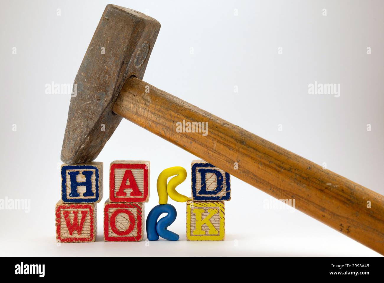Concept image of hard work with a hammer on white background Stock ...