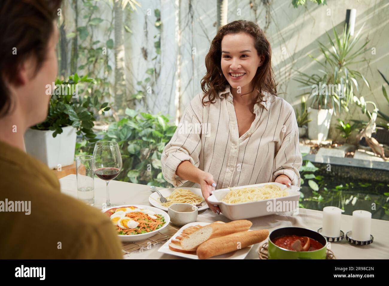 Woman passing plate food table hi-res stock photography and images - Alamy
