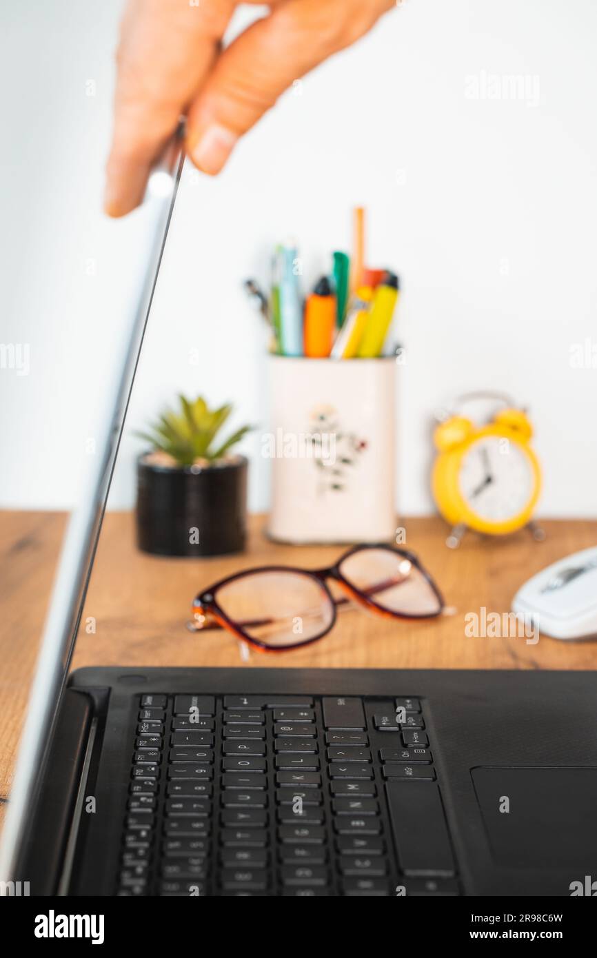 Opening computer notebook on office desk, concept, starting work ...