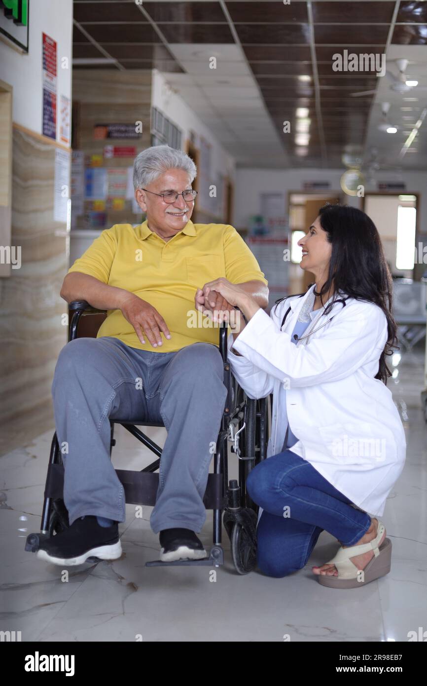 Doctor taking care of physically disabled patient hi-res stock ...