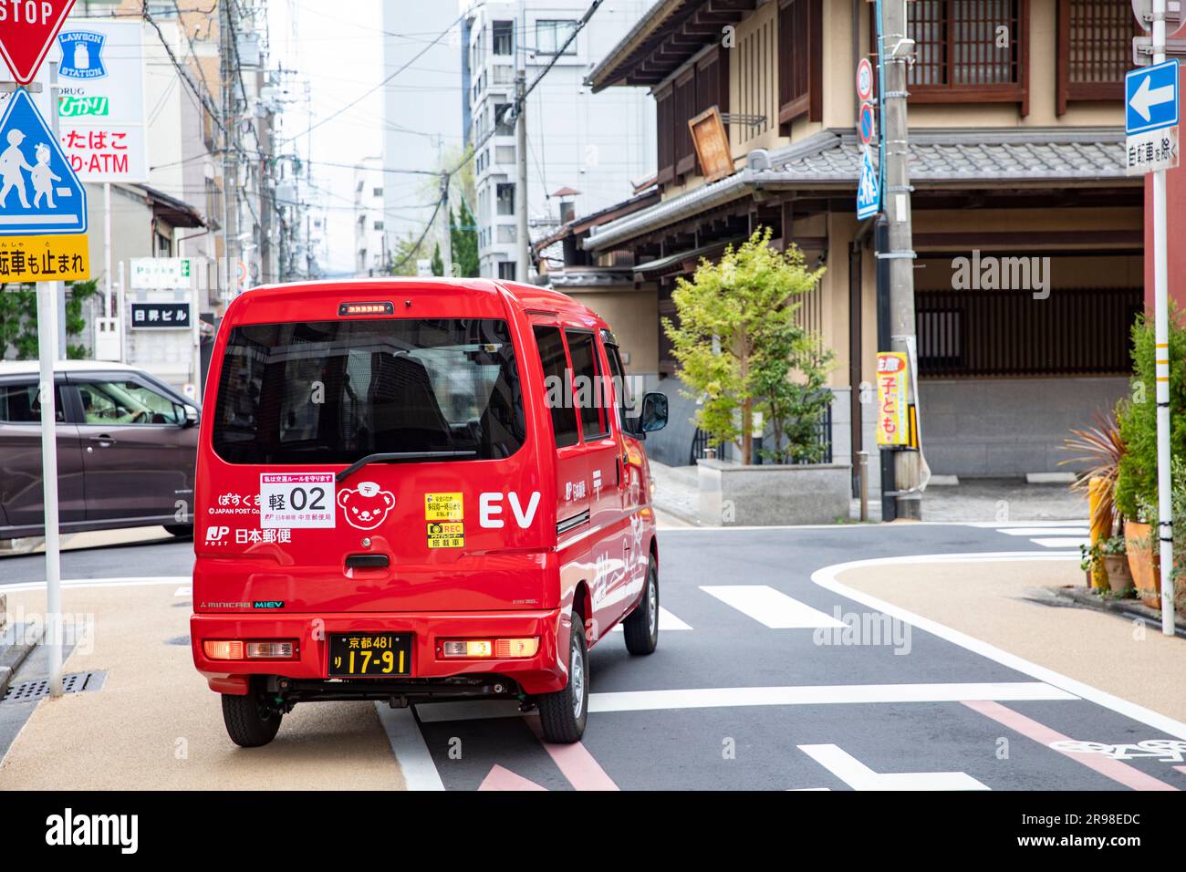 Kyoto japan red postal post mail van electric vehicle in downtown kyoto ...