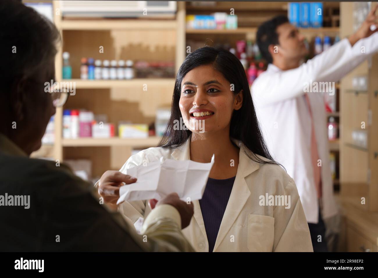 chemist man standing in pharmacy - drugstore. Close up of pharmacist at ...