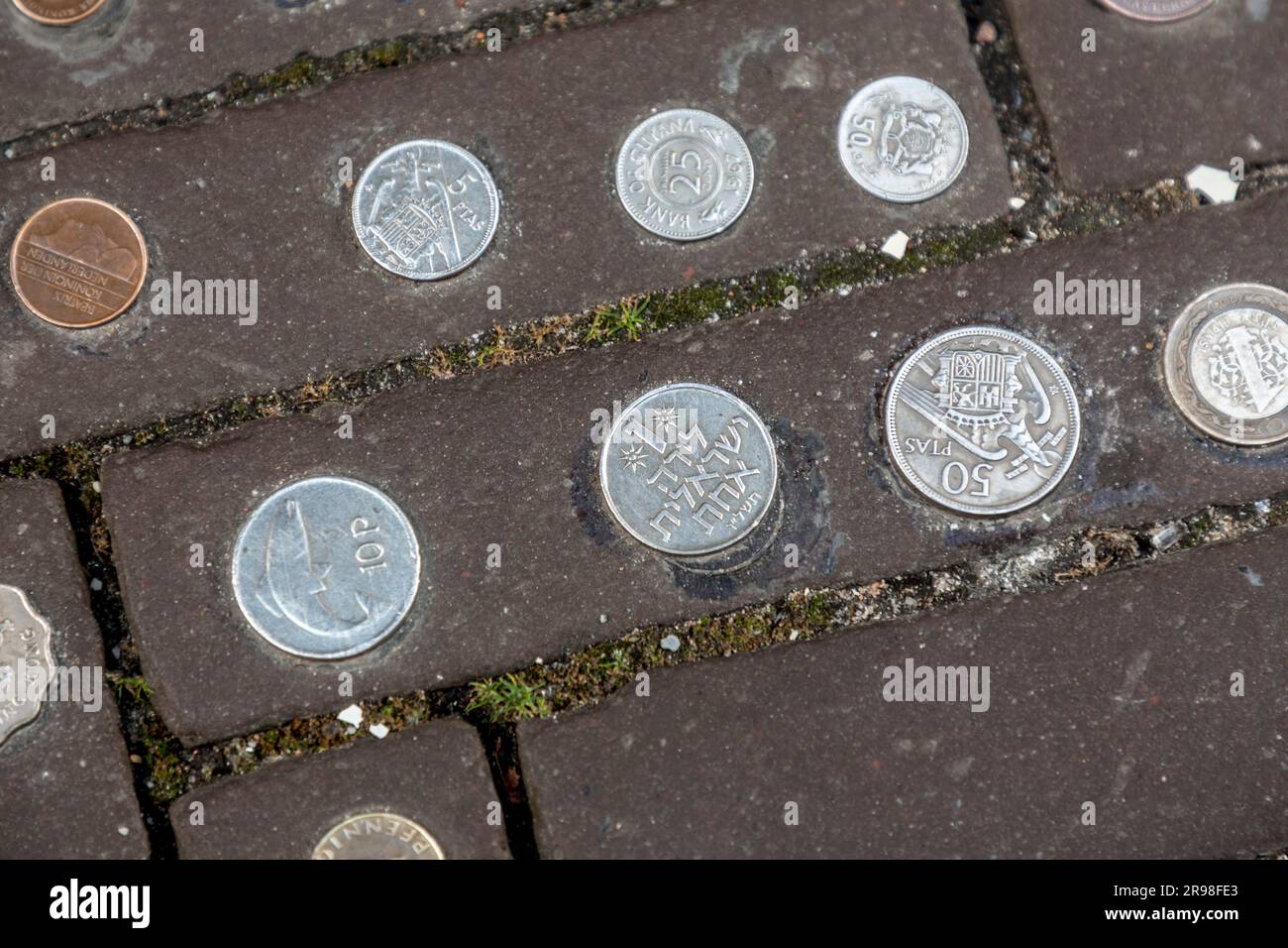 Street art on the pavement made with coins from all over the world, The ...
