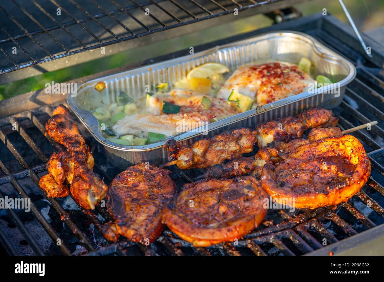 grilled chicken and fish on the grill Stock Photo - Alamy