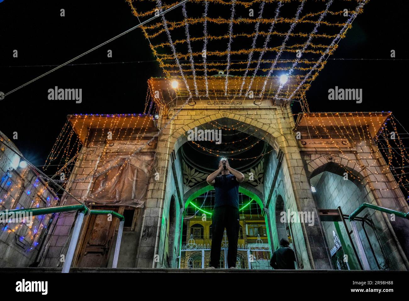 A Kashmiri Muslim prays outside the Shah-e Hamdan Mosque on the death ...