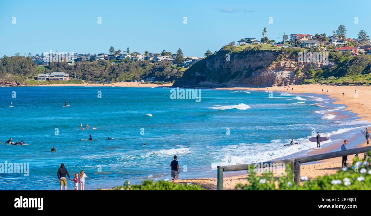 A panoramic view of surfboard riders and beach goers at Mona Vale Beach ...