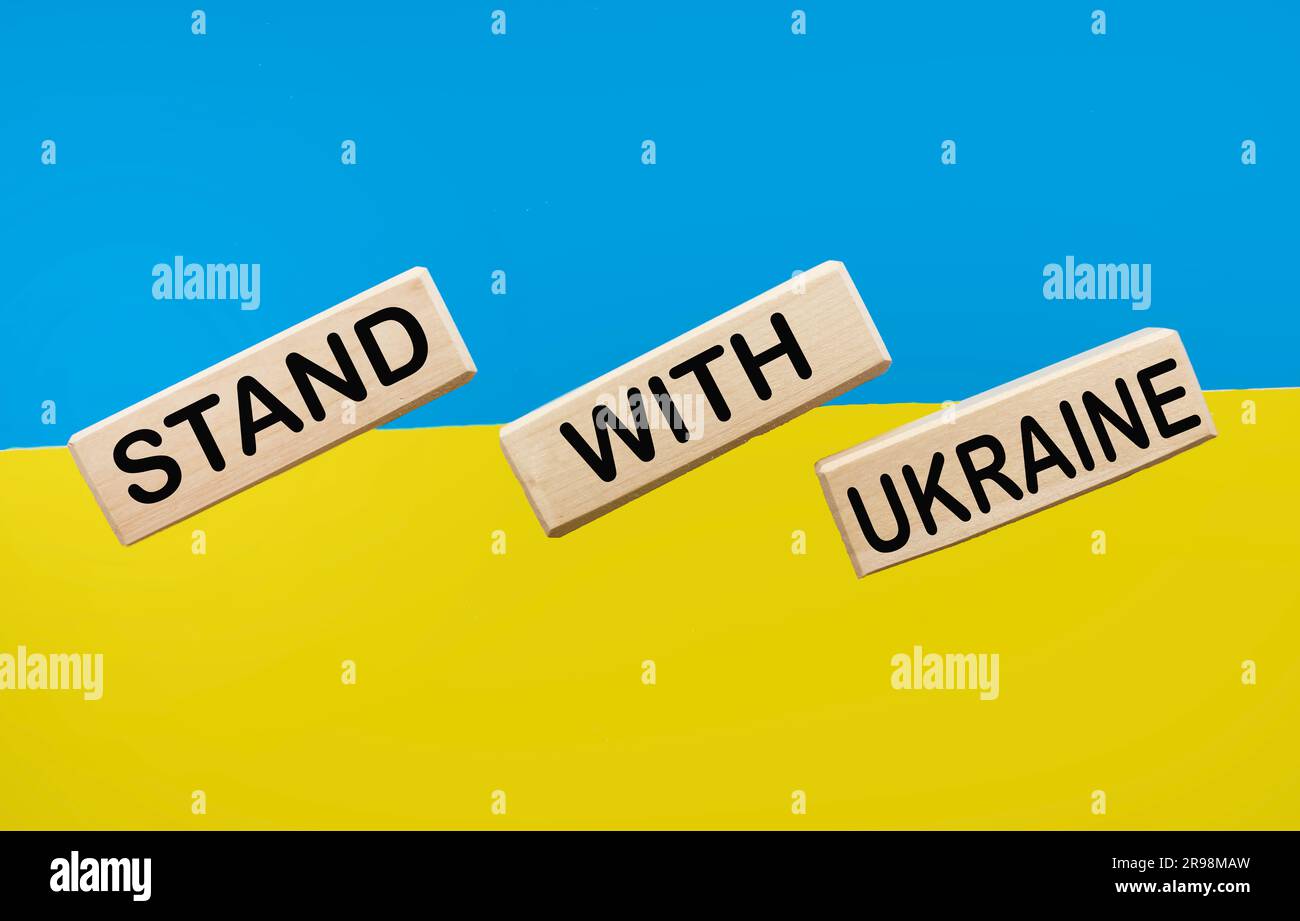 Wooden blocks with the text Stand for Ukraine on the table with the ...