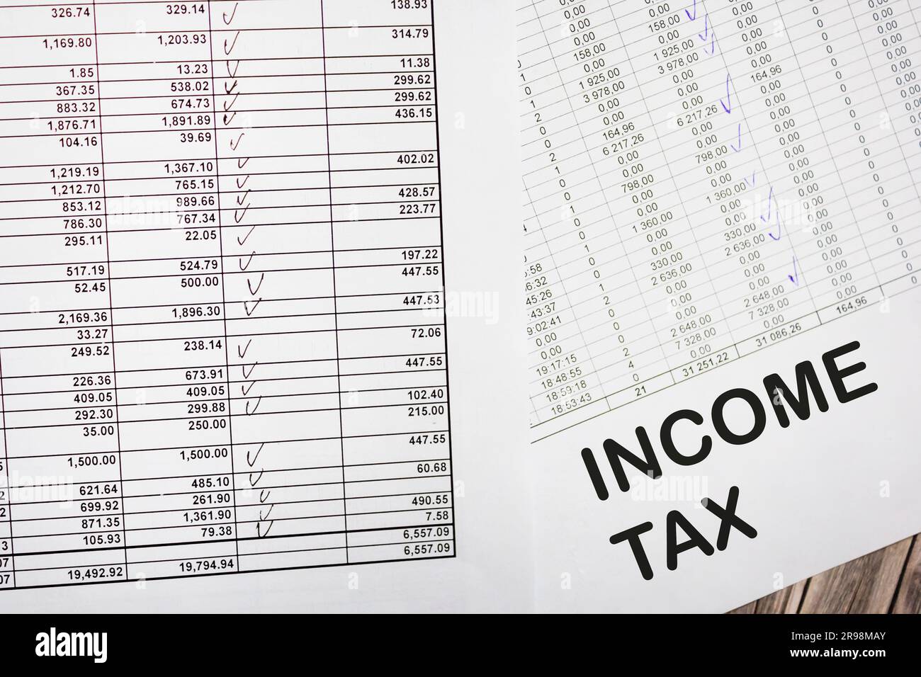Text Income tax on a sheet of paper with numbers on documents, on a ...