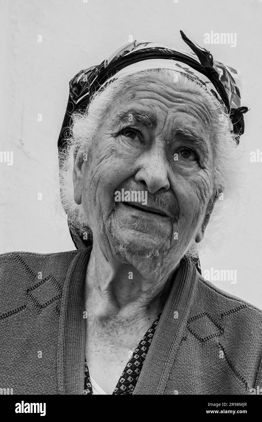 Portrait of an old Greek lady, wearing a scarf. Naxos, Greece. Black ...
