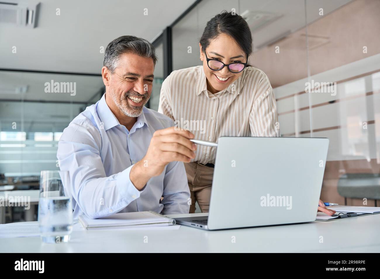 Happy diverse professional employees working in office using laptop ...