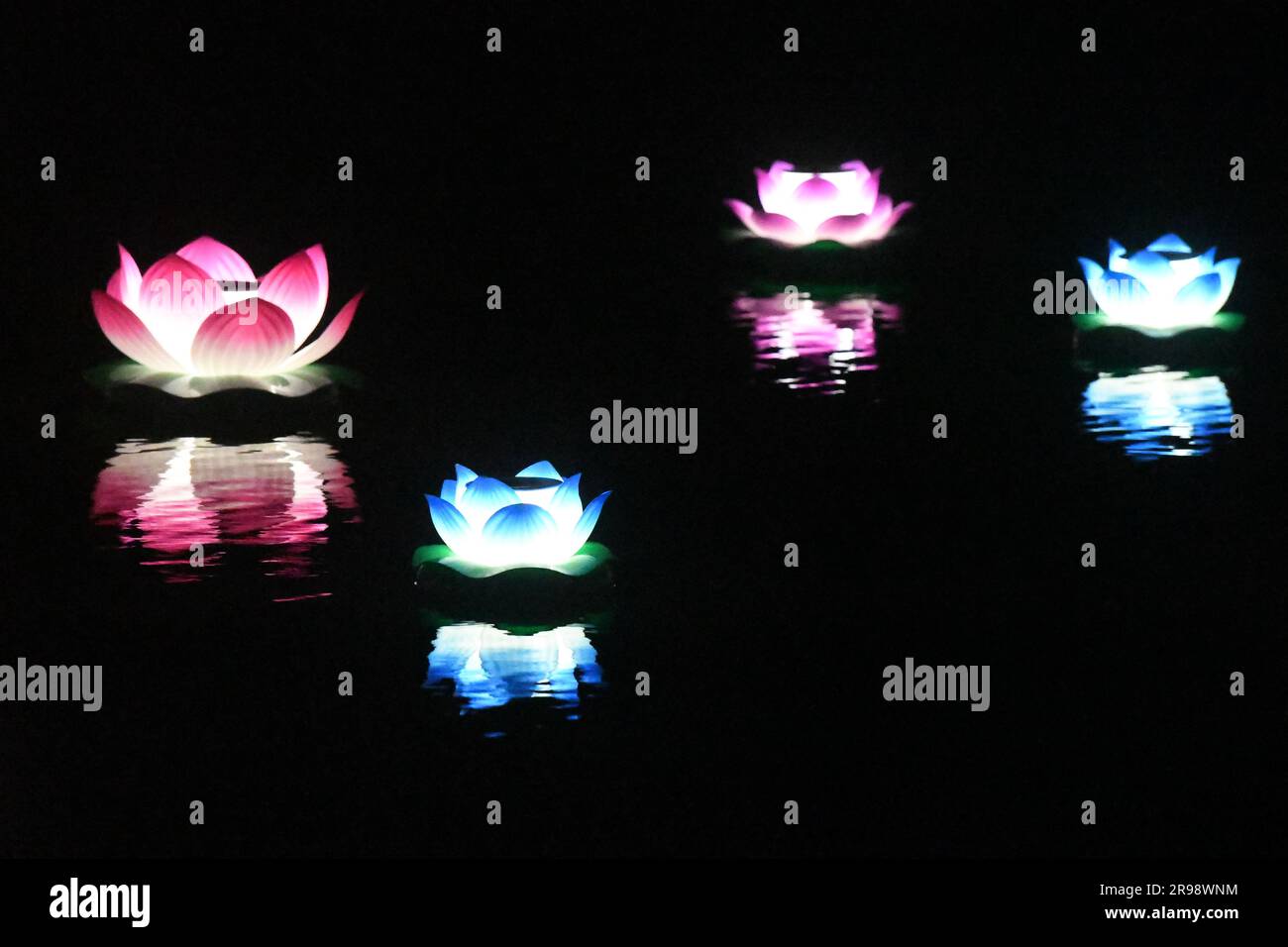 QINGDAO, CHINA - JUNE 24, 2023 - River lanterns float on the water of ...