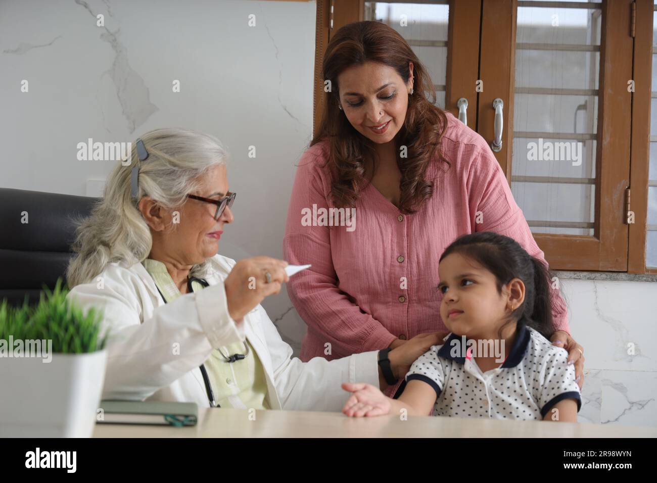 happy family visiting doctor for personal consultation with their ...