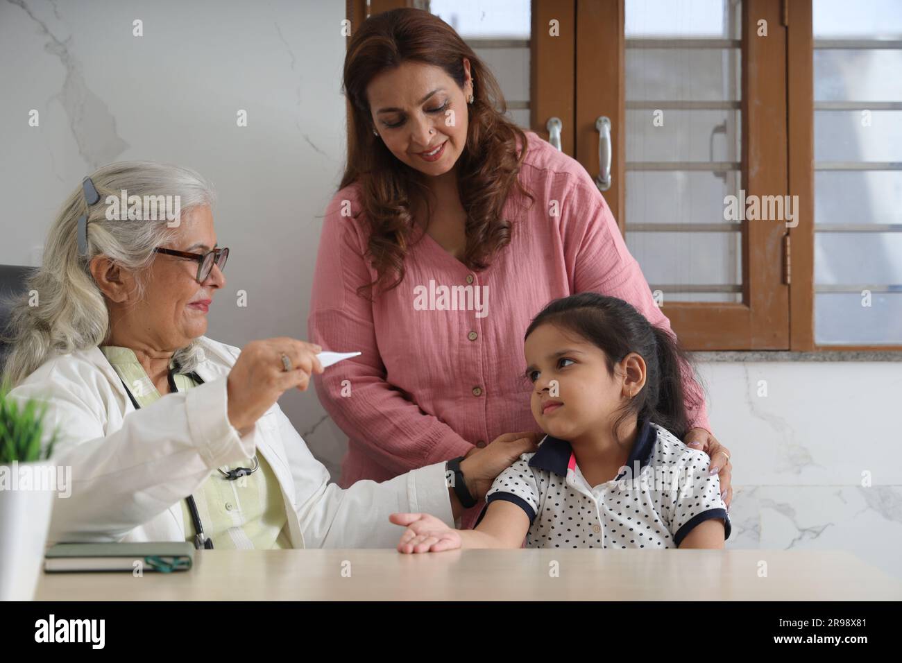 happy family visiting doctor for personal consultation with their ...
