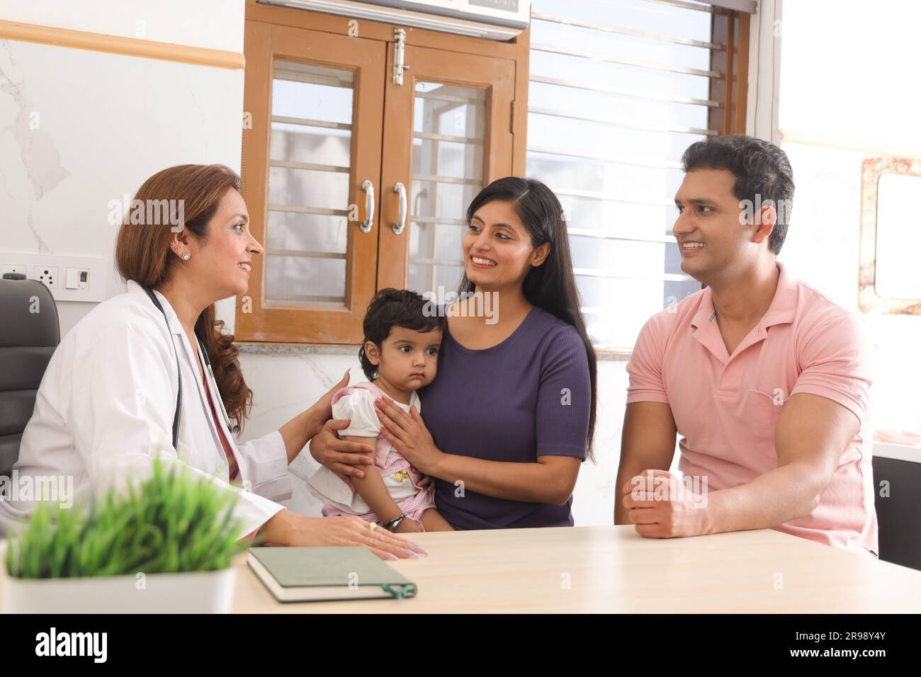 Family with girl child consulting female doctor in cabin, health ...