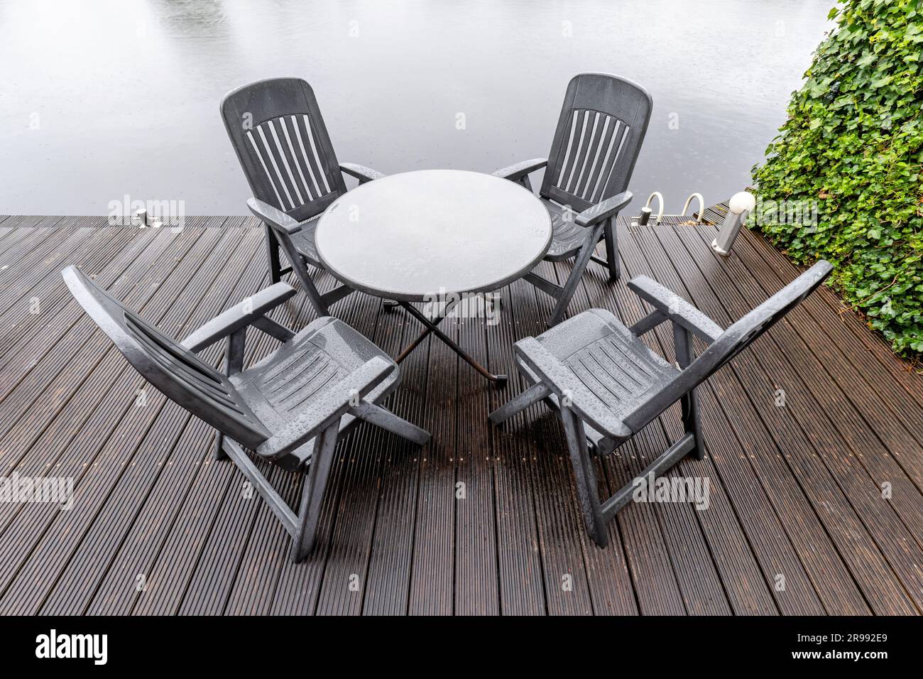 seating group on waterside terrace in rain Stock Photo - Alamy