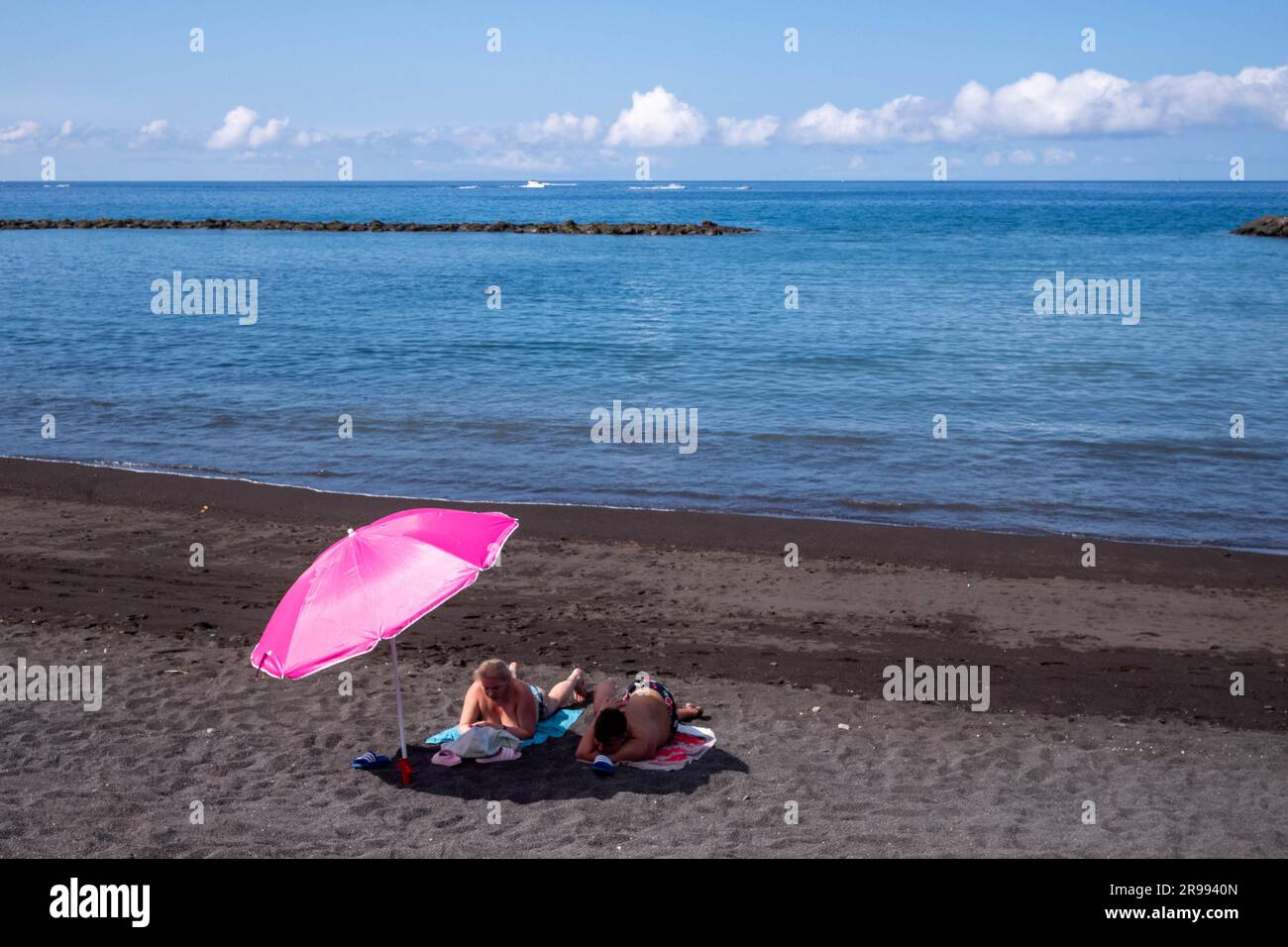 Pink Parasol on beach Stock Photo - Alamy