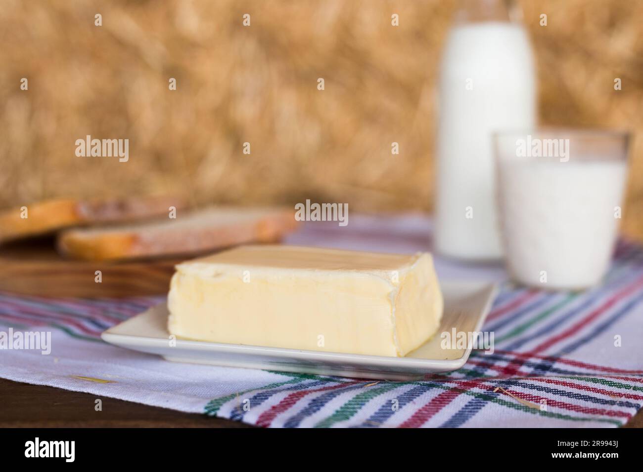 butter, milk, cottage cheese, bread on the table in the barn against ...