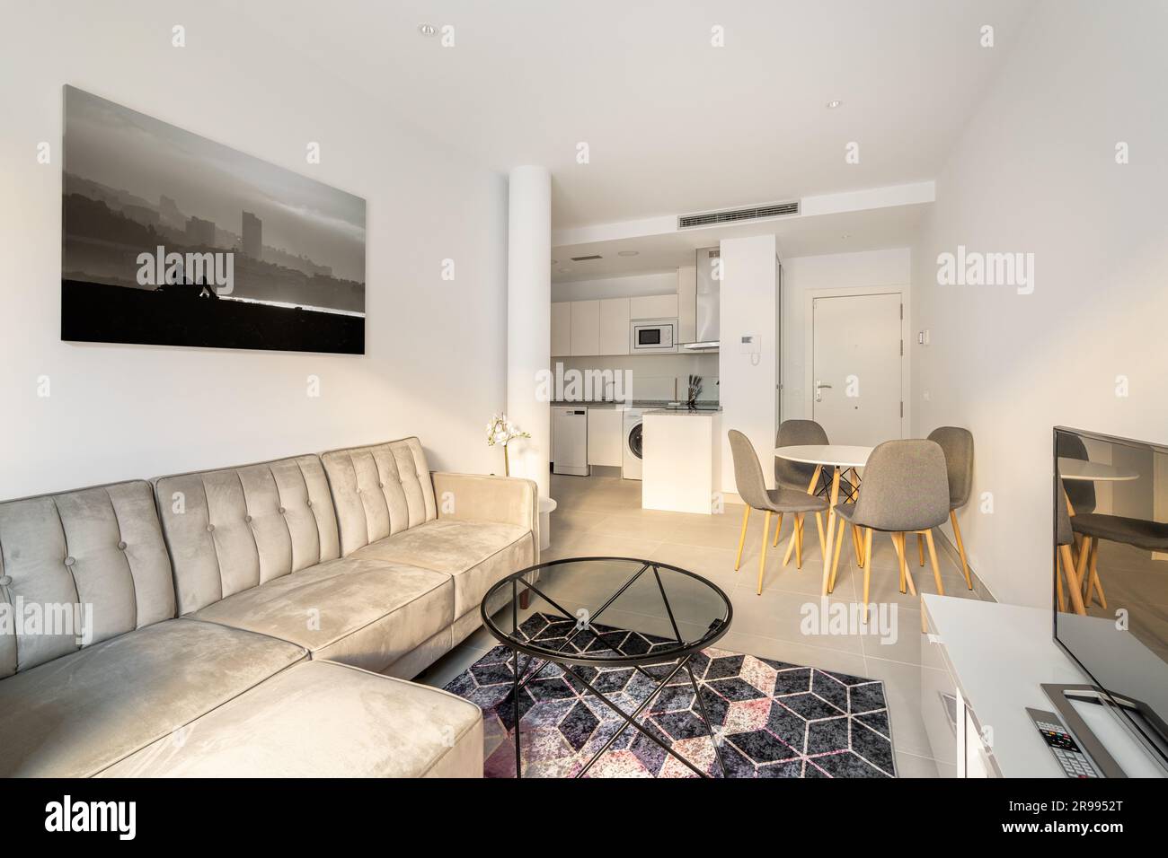 Living room - kitchen with a corner sofa, tables and chairs and a TV ...