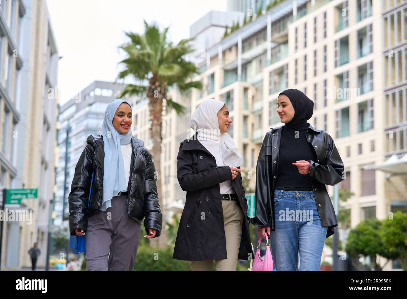 Young muslim women with hijabs walking. Young muslim friends hanging ...