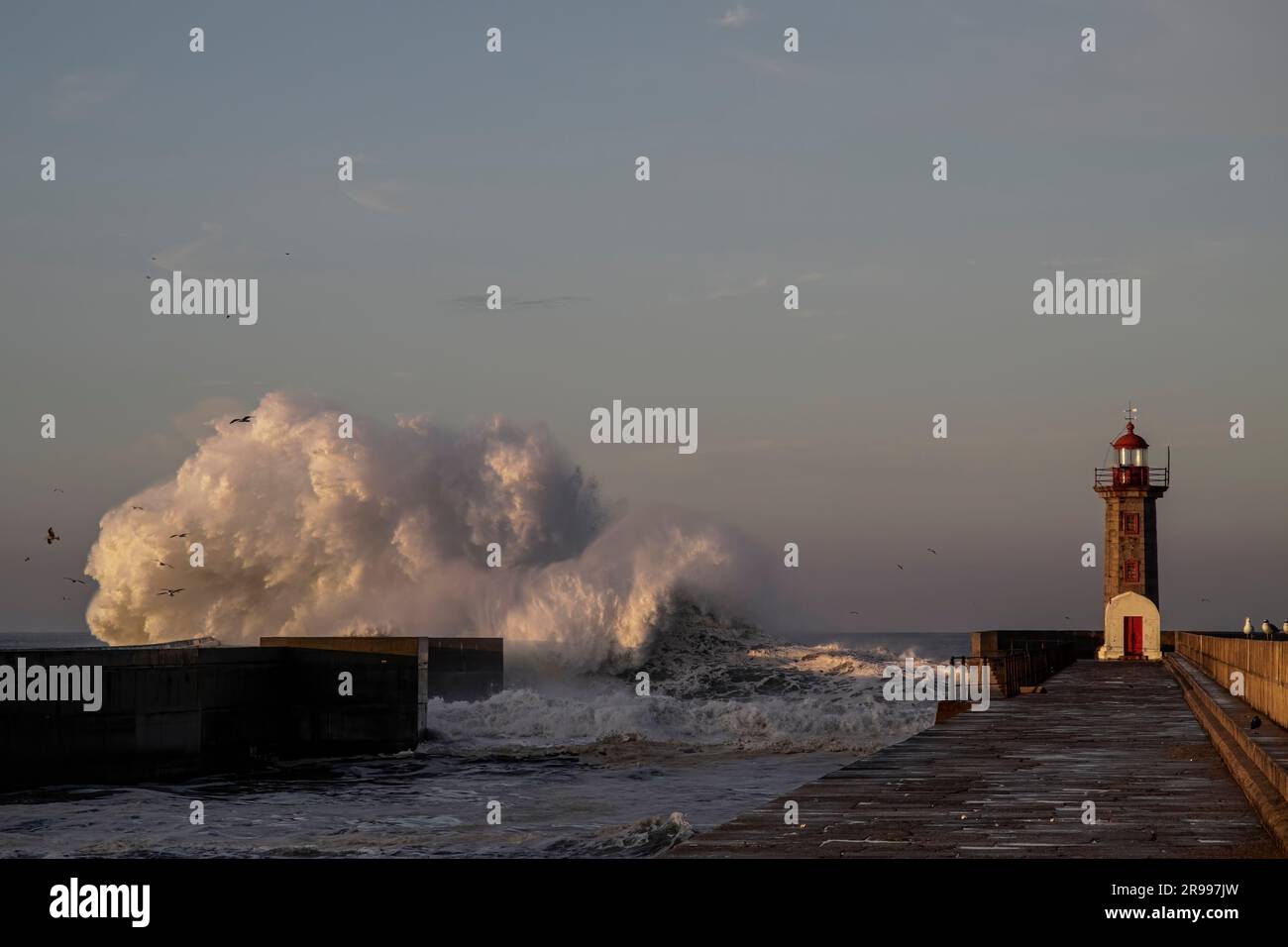 Big stormy wave splash at dawn. Douro river mouth south piers and ...