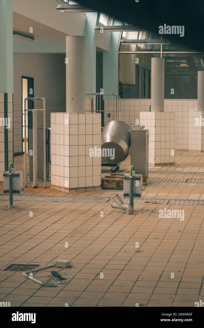 A close-up view of an old and abandoned building with white tiles on ...