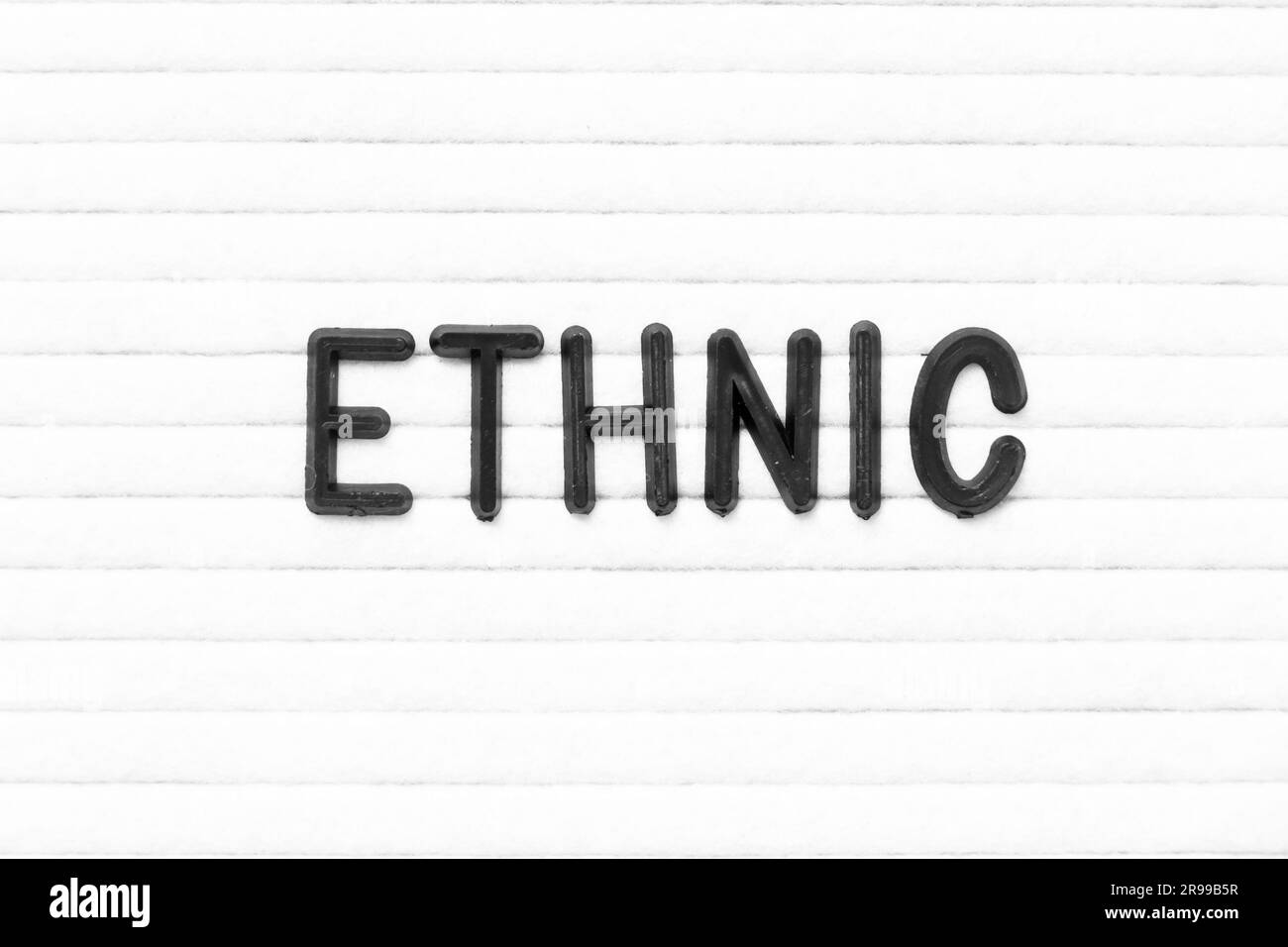 Black color letter in word ethnic on white felt board background Stock ...