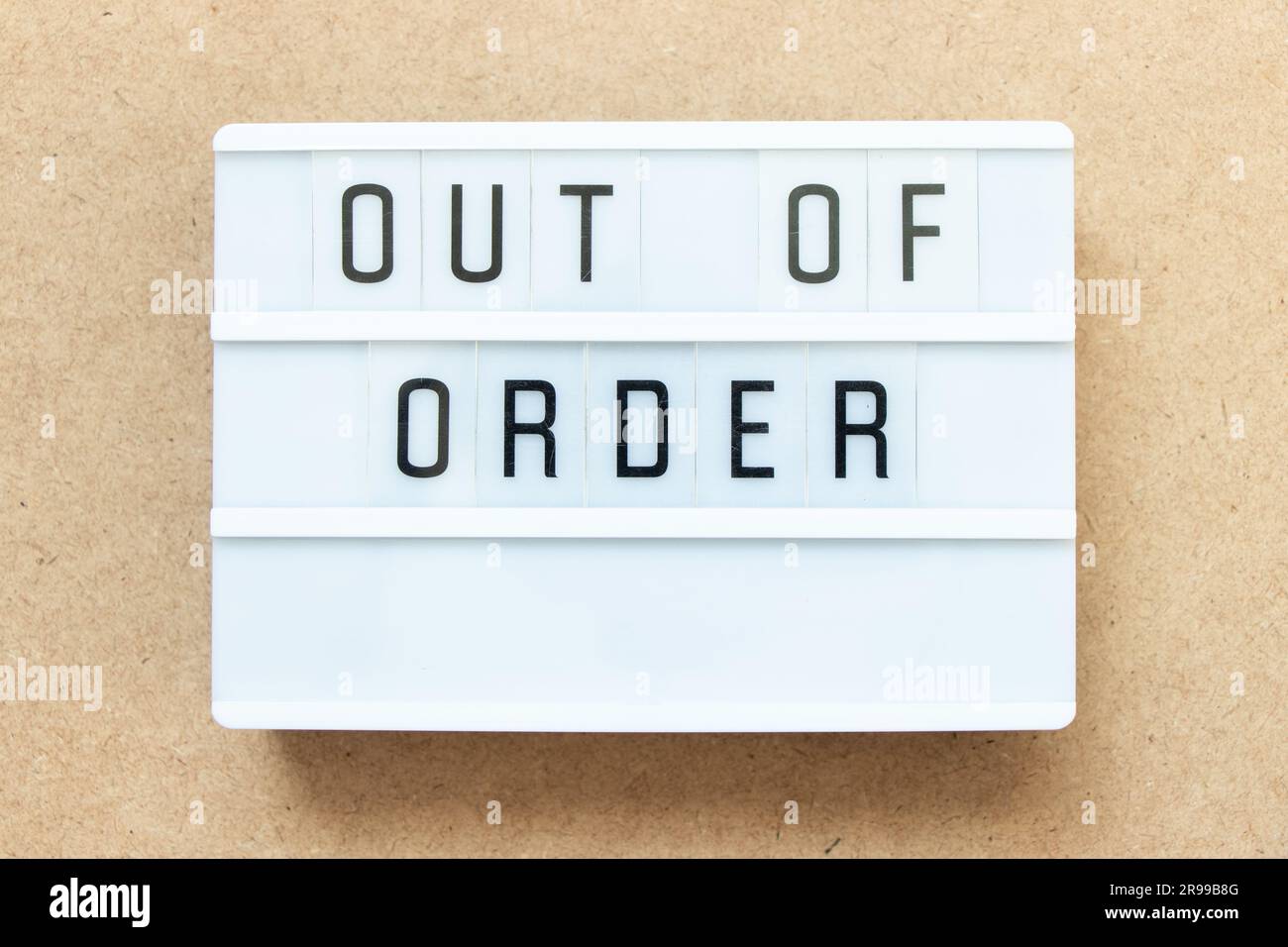 Lightbox with word out of order on wood background Stock Photo - Alamy