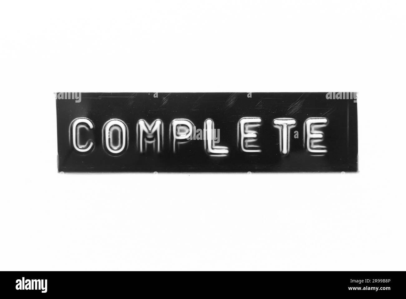 Black color banner that have embossed letter with word complete on ...