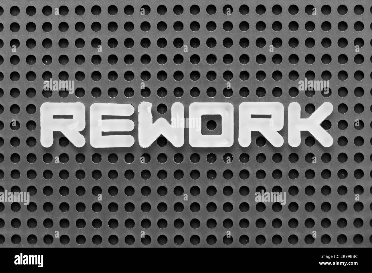 White alphabet letter in word rework on black pegboard background Stock ...