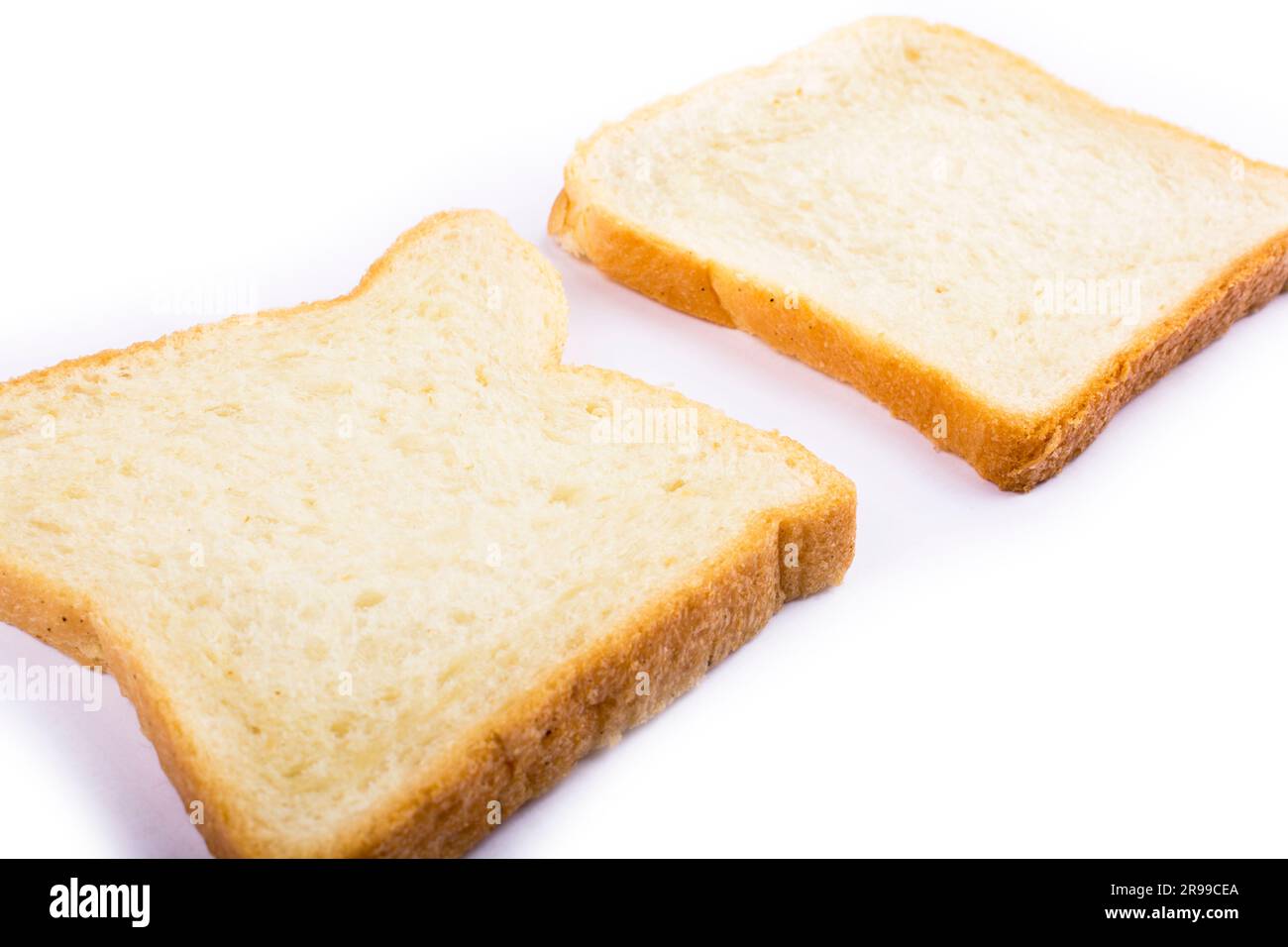 two slices of bread for toast on a white background Stock Photo - Alamy