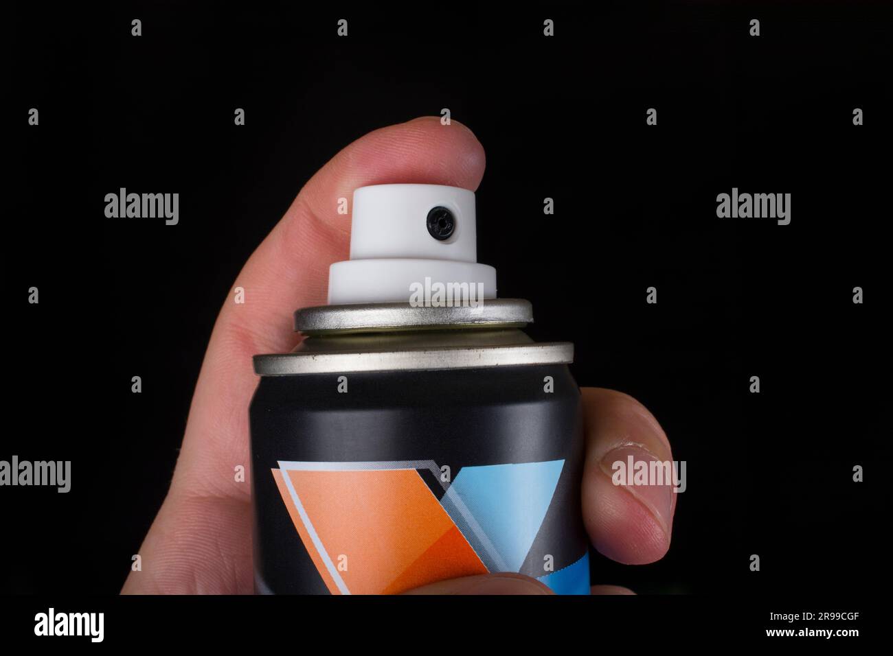 Close-up view of a human hand and pressed bottle of spray isolated on a ...