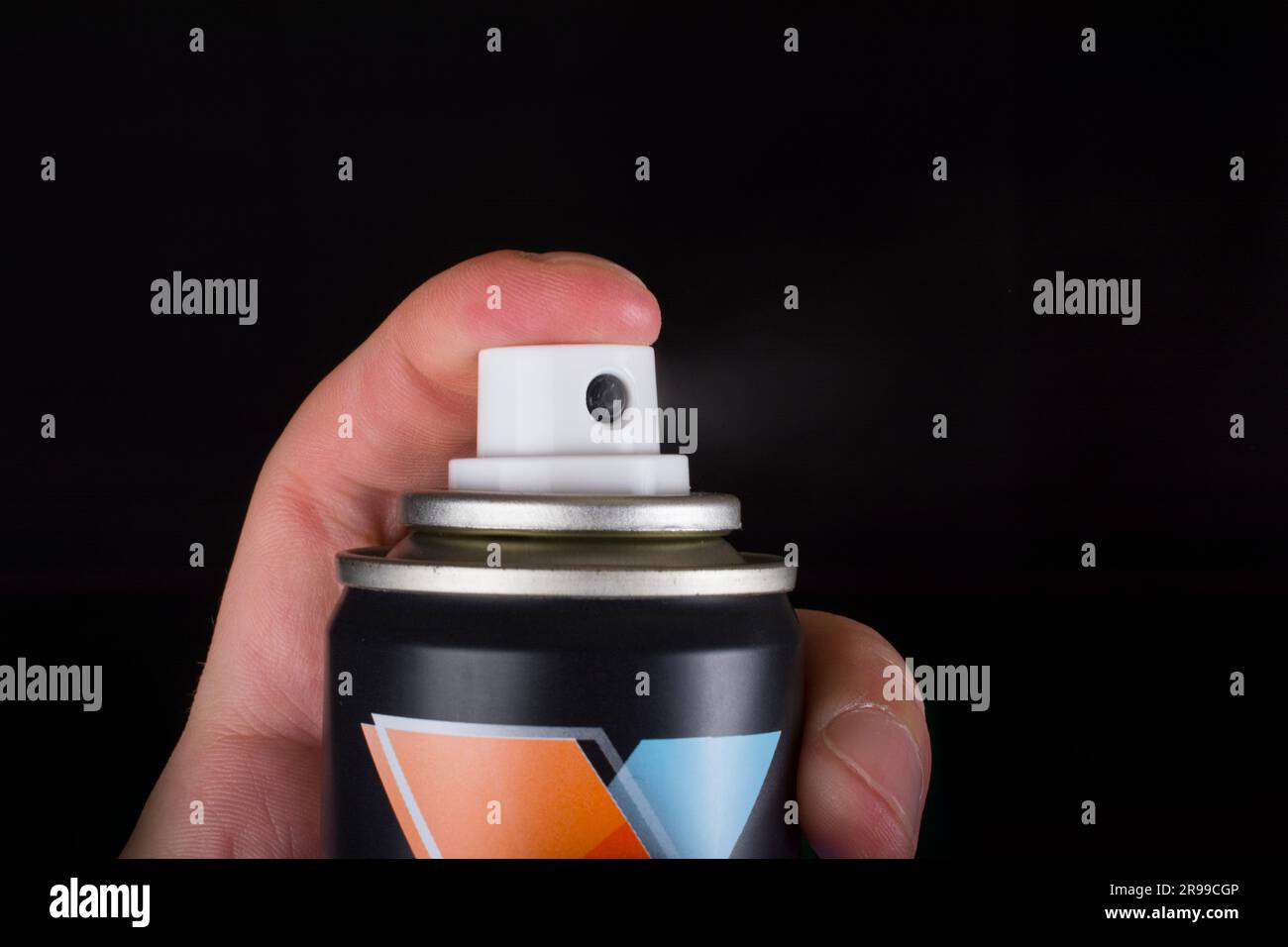 Close-up view of a human hand and pressed bottle of spray isolated on a ...