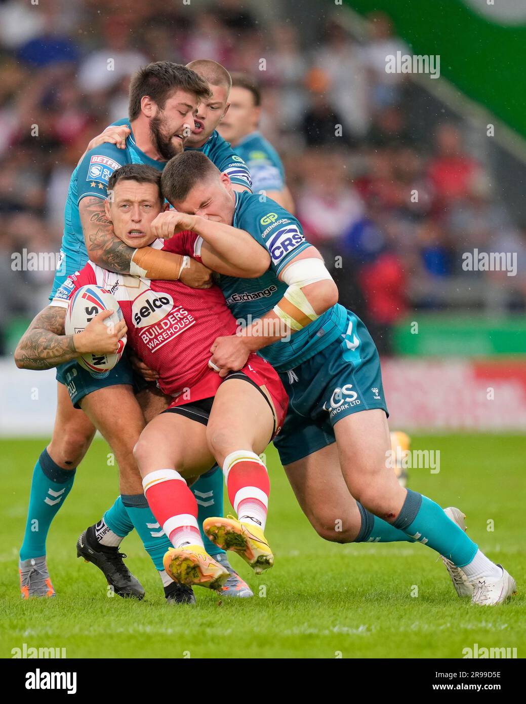 Deon Cross #28 of Salford Red Devils is tackled by Joe Shorrocks #19 of ...