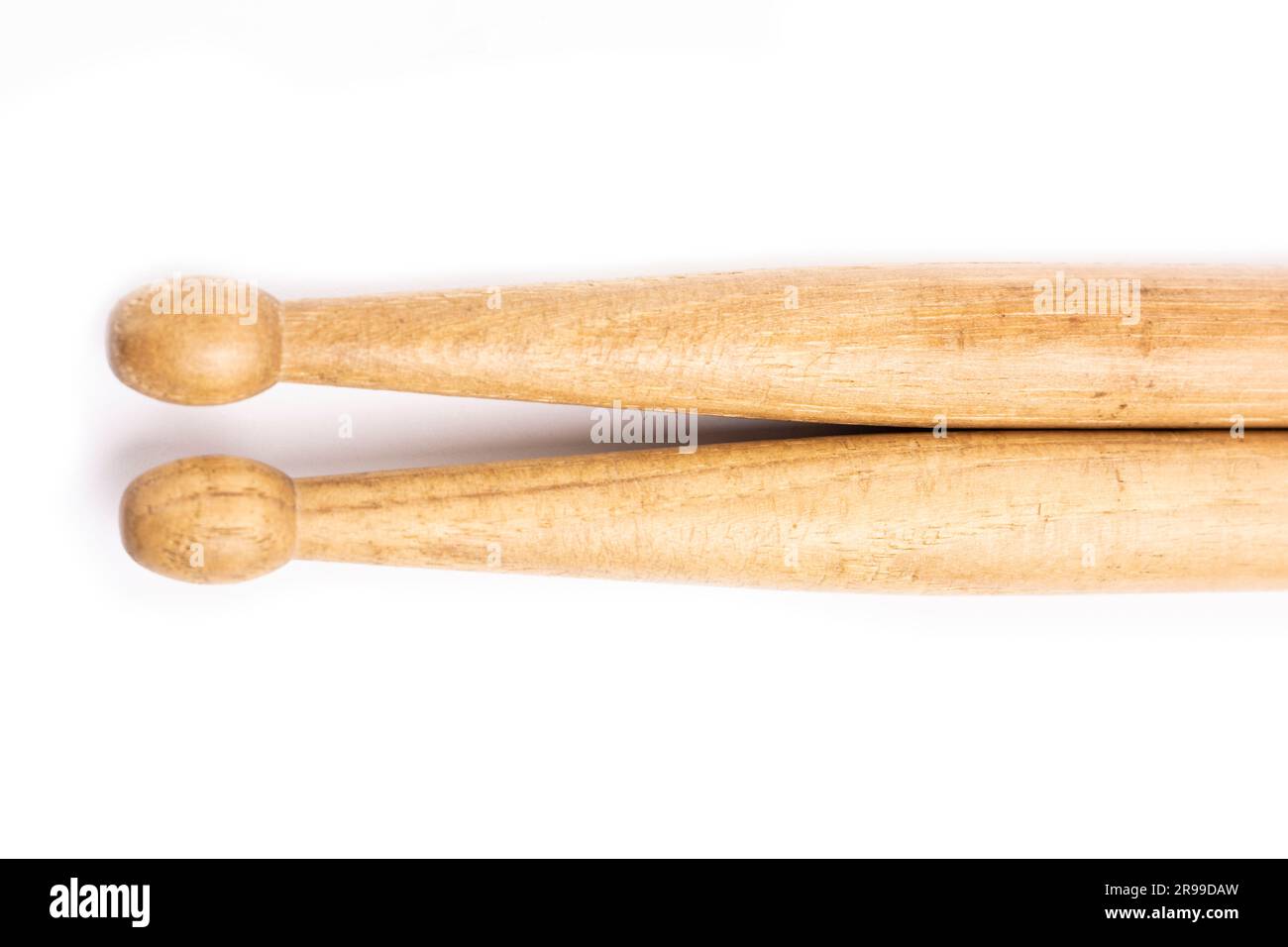 Two wooden drum sticks lying on each other isolated on white background ...