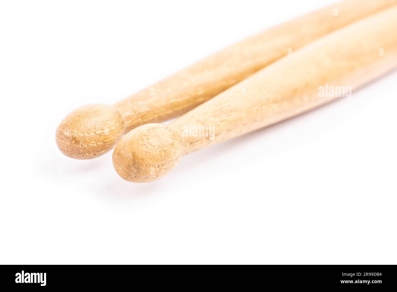 Two wooden drum sticks lying on each other isolated on white background ...