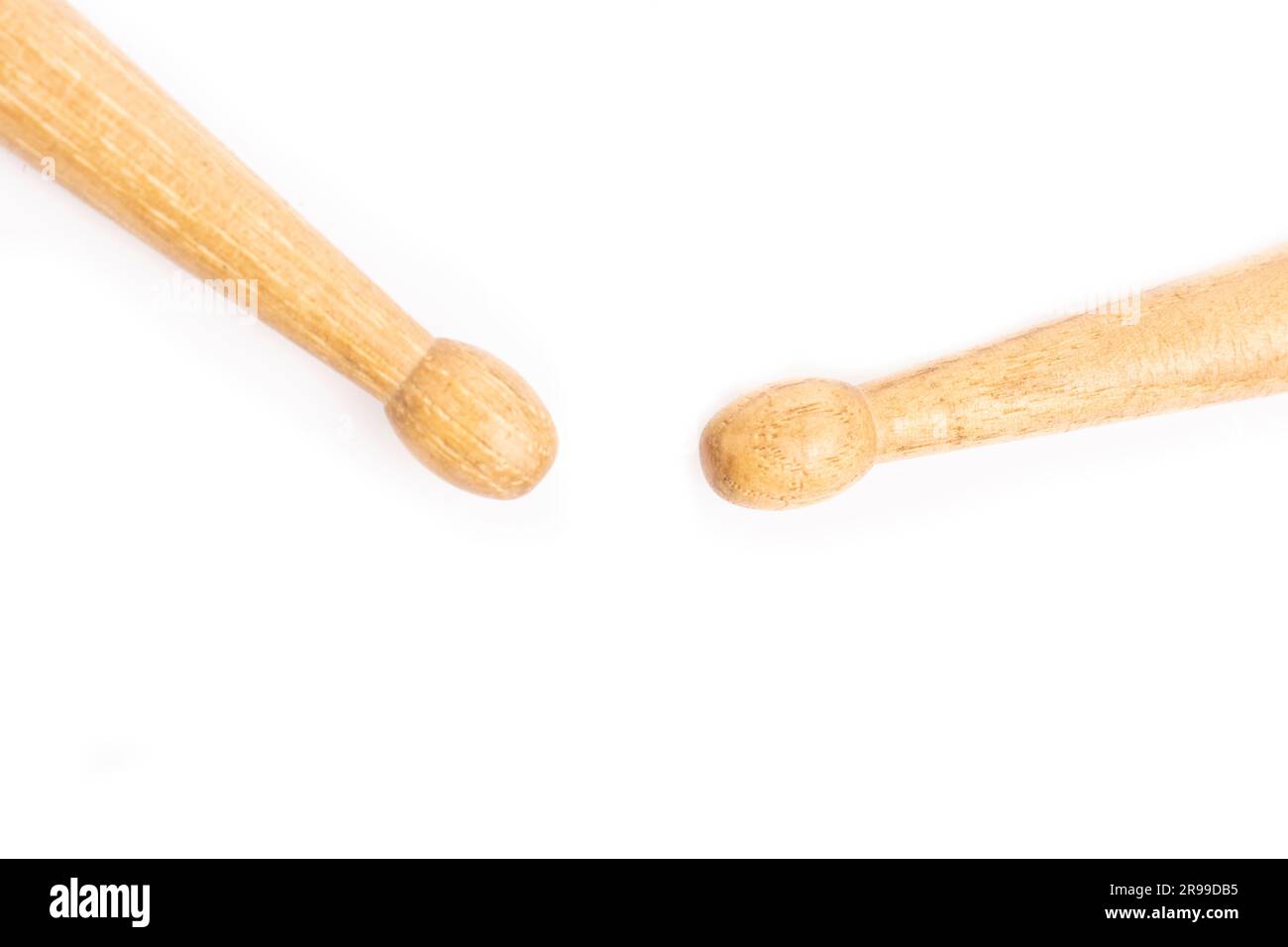 Two wooden drum sticks lying on each other isolated on white background ...