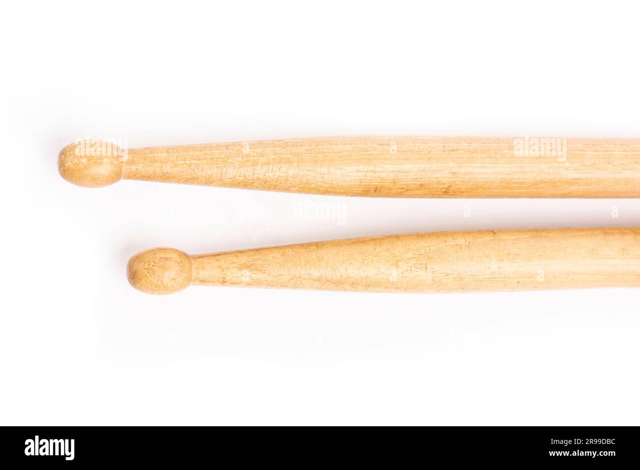 Two wooden drum sticks lying on each other isolated on white background ...