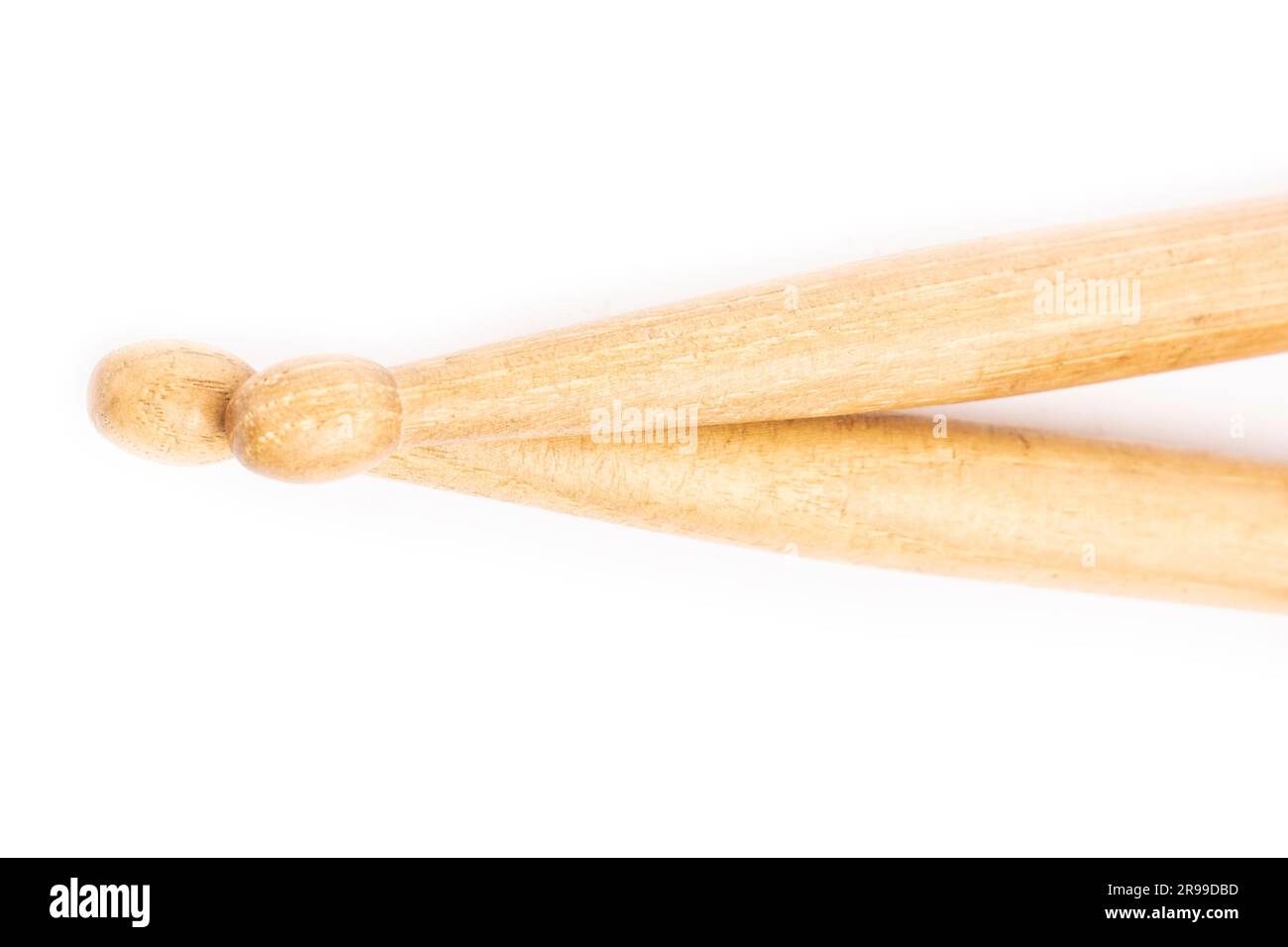 Two wooden drum sticks lying on each other isolated on white background ...