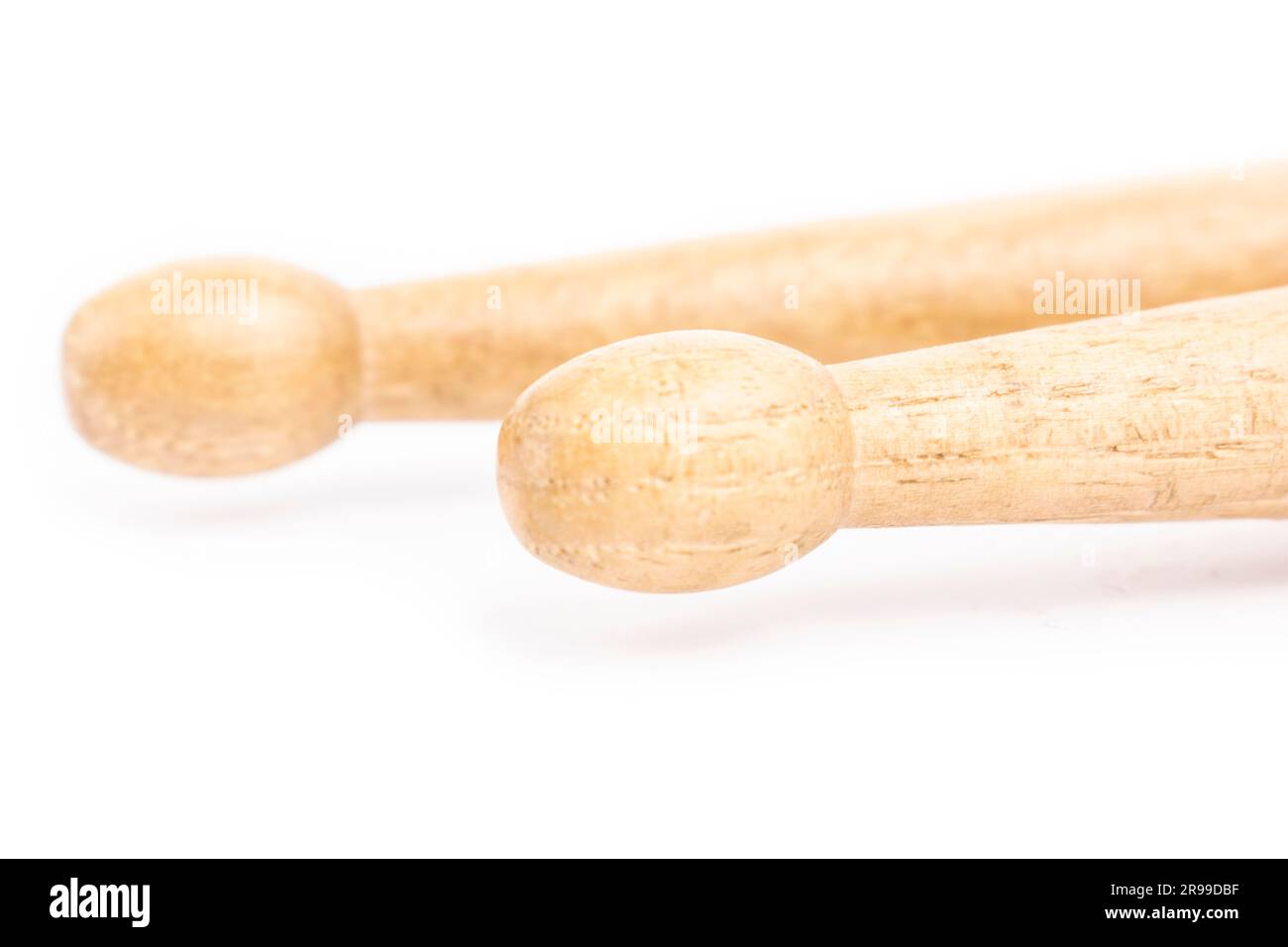 Two wooden drum sticks lying on each other isolated on white background ...