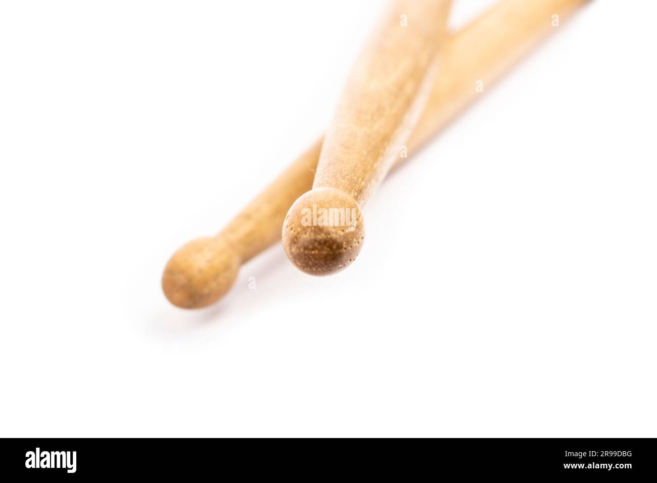 Two wooden drum sticks lying on each other isolated on white background ...