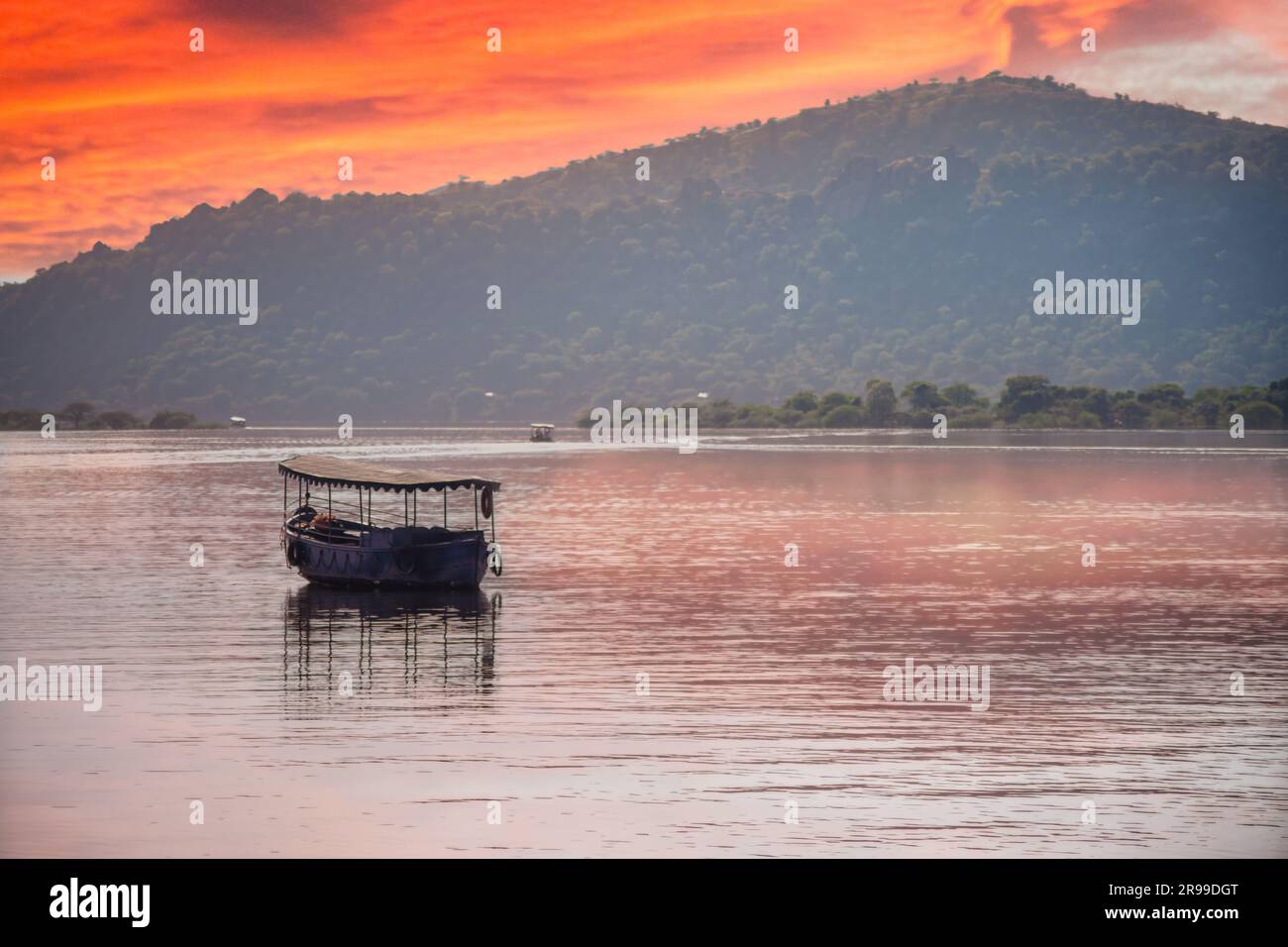 abandoned boat adrift marooned in the middle of water of lake pichola ...