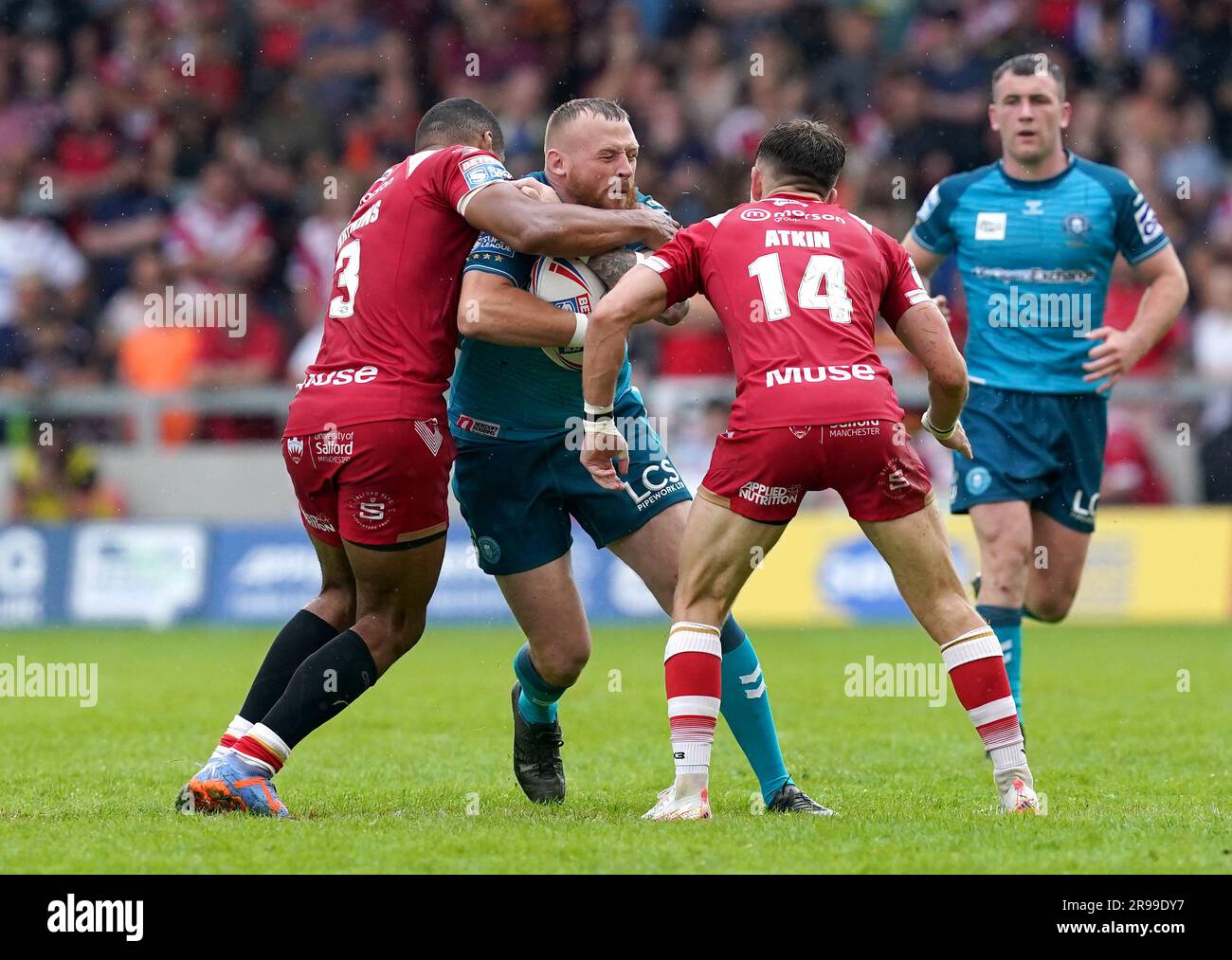 Wigan Warriors' Brad Singleton (centre) is tackled by Salford Red ...
