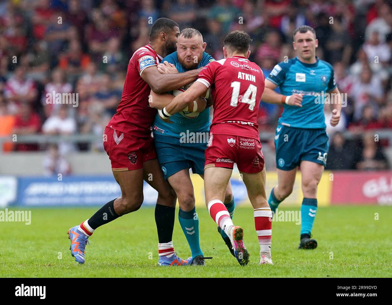 Wigan Warriors' Brad Singleton (centre) is tackled by Salford Red ...