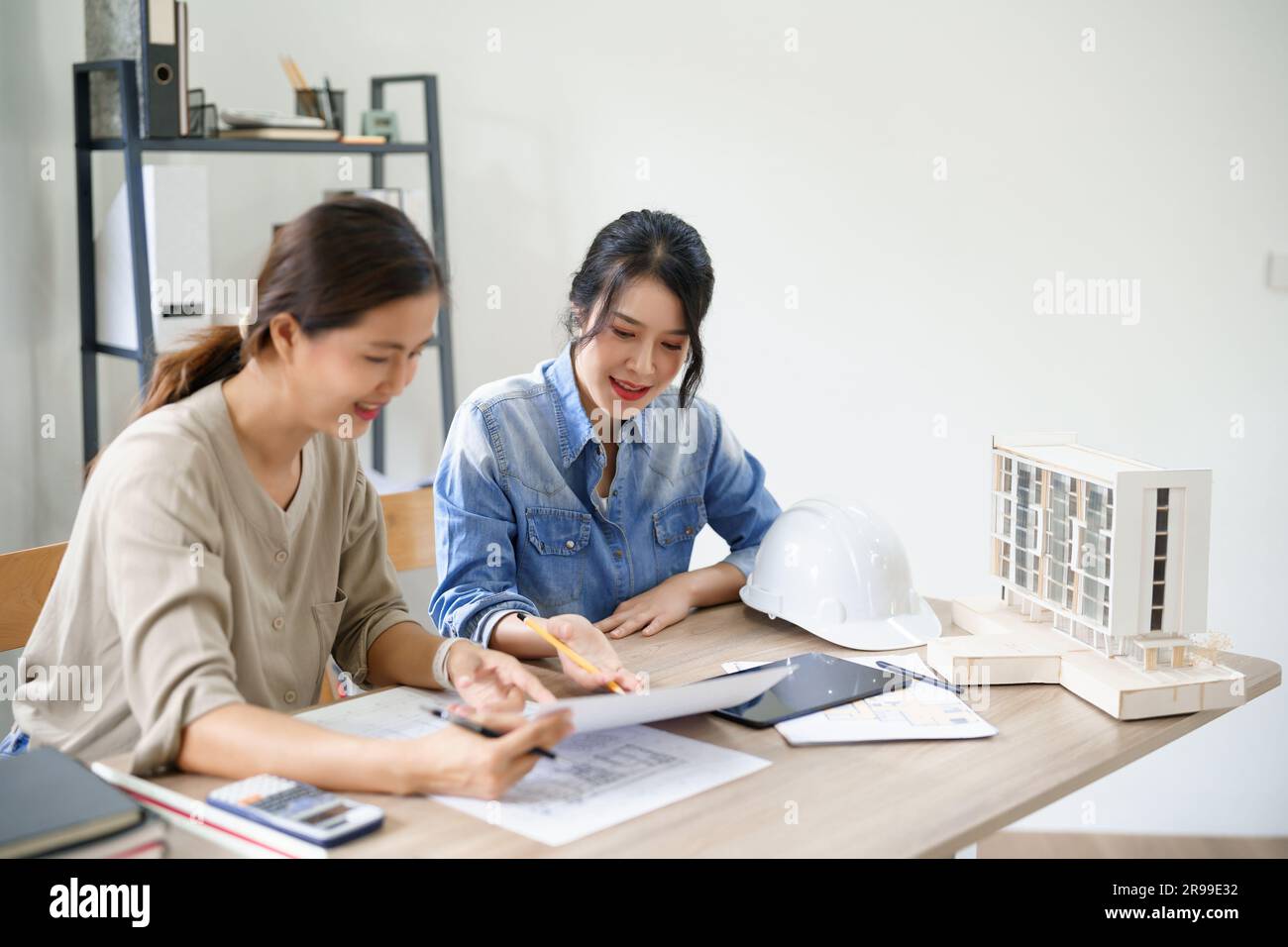 Concept of engineering consulting, Two female engineers discussing ...