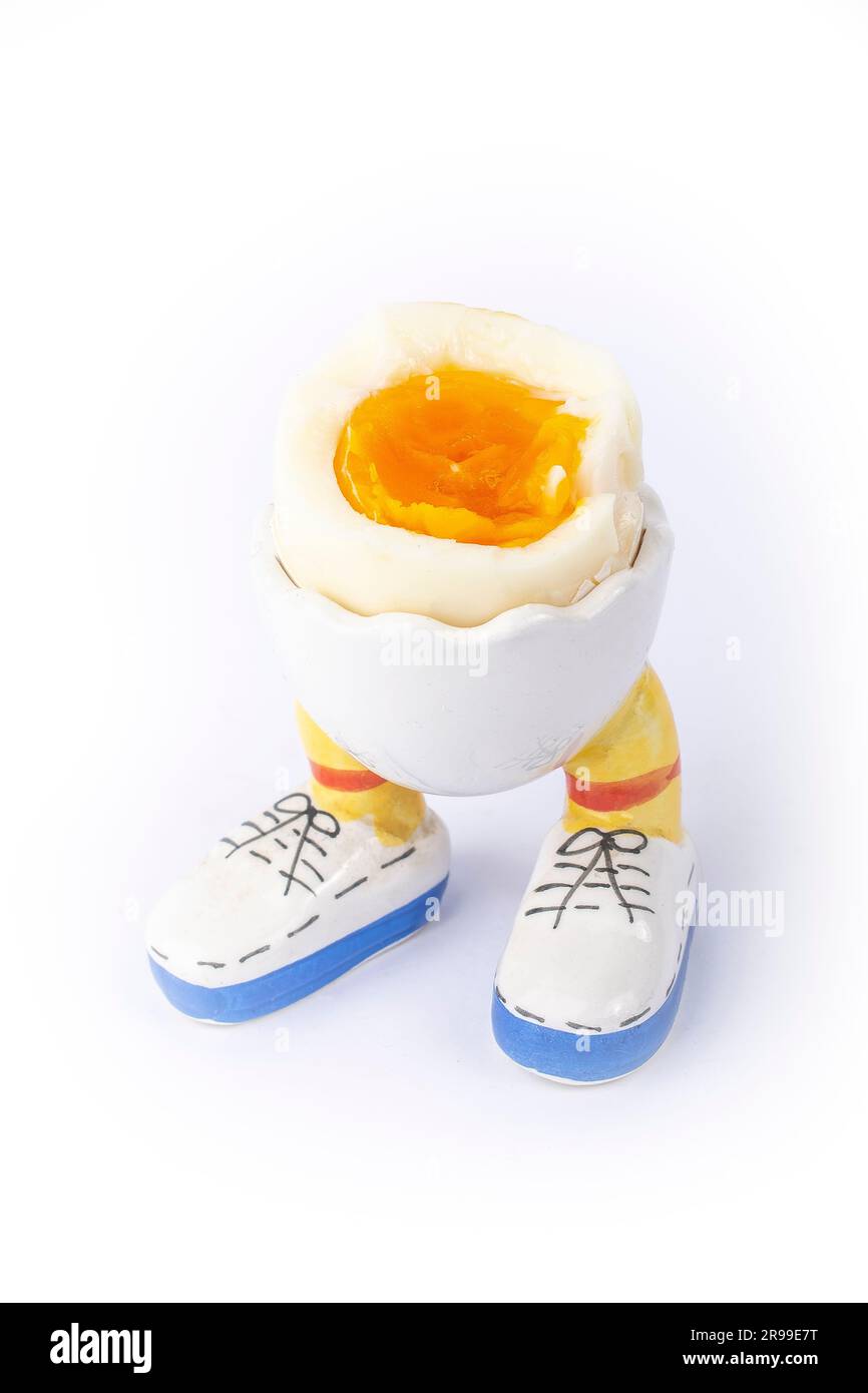 boiled egg open half in stand in the form of legs isolate Stock Photo ...