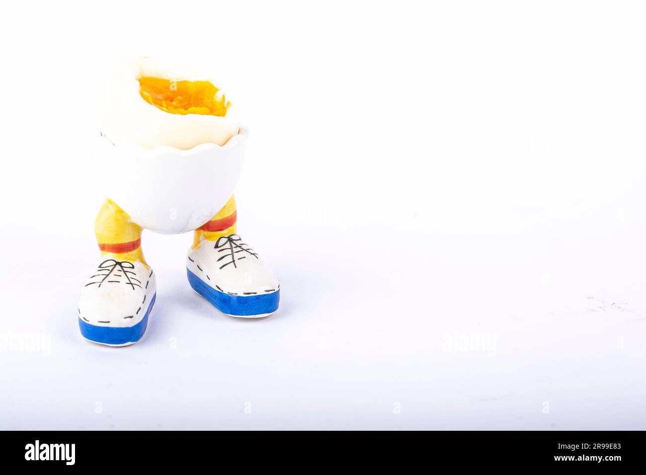 boiled egg open half in stand in the form of legs isolate Stock Photo ...
