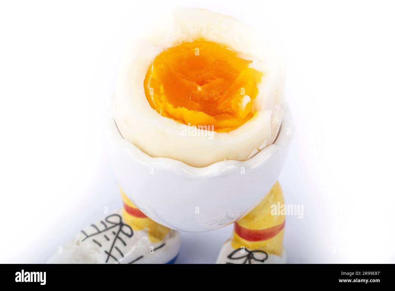 boiled egg open half in stand in the form of legs isolate Stock Photo ...